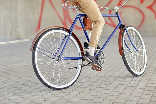 people, style and lifestyle - close up of hipster man riding fixed gear ...