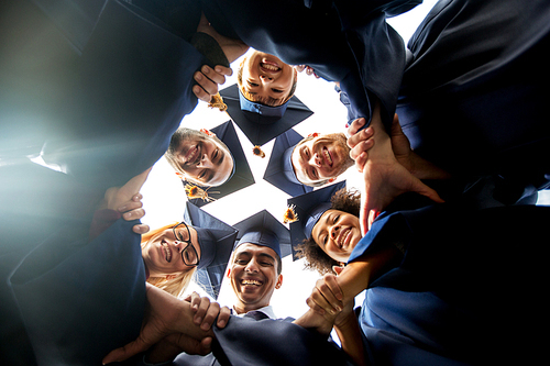 education, graduation, unity and people concept - group of happy ...