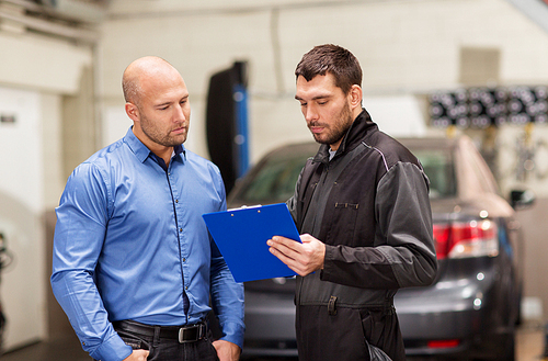 auto service, repair, maintenance and people concept - mechanic with ...