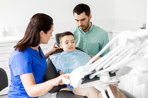 medicine, dentistry and healthcare concept - father and son visiting ...