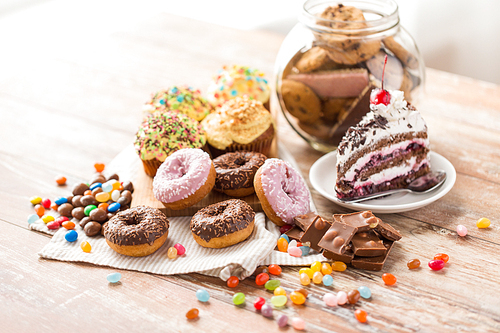 junk food, sweets and unhealthy eating concept - close up of glazed ...