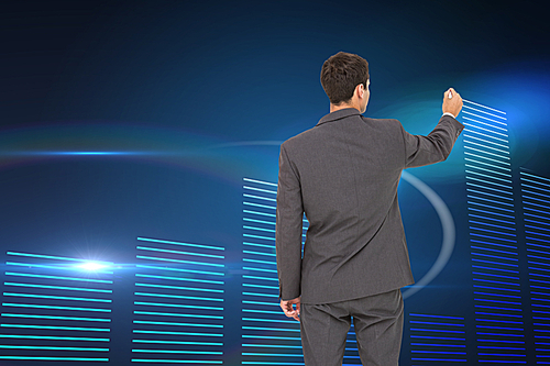 Composite image of businessman standing back to camera writing with ...