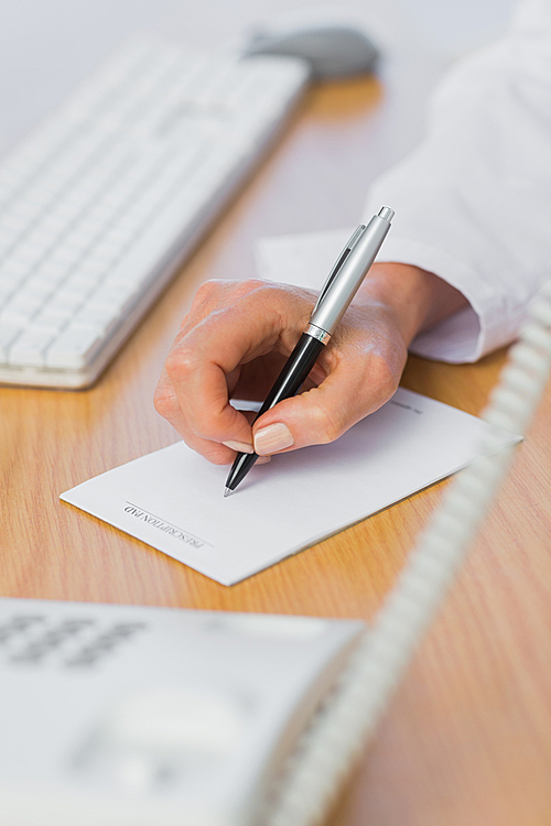 Detail shot of a hand using phone while writing notes | 유토이미지 | 상세페이지 ...
