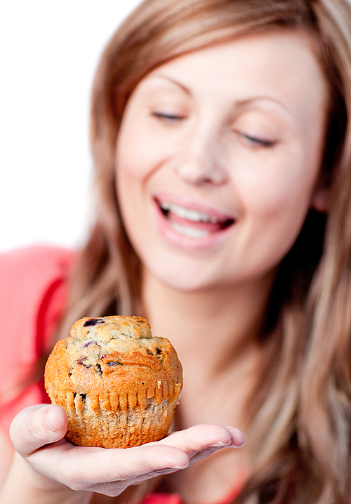 유토이미지 | Radiant woman is eating a muffin