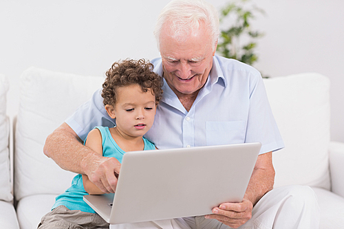 유토이미지 | Grandfather and grandson watching a laptop screen