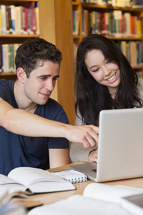 Two students learning on the laptop in a library | 유토이미지 | 상세페이지 | 베이직샵 ...