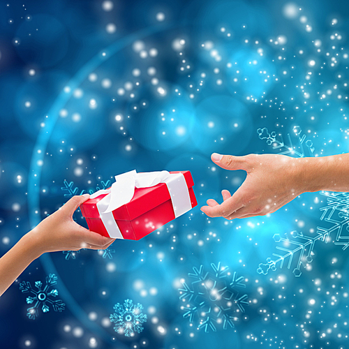 Composite image of couple passing a wrapped gift | 유토이미지 | 상세페이지 | 베이직샵 ...