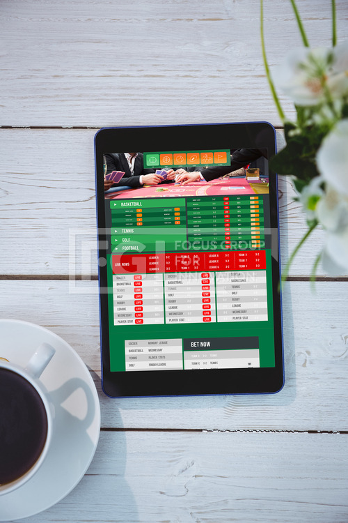 유토이미지 | Gambling app screen against tablet on desk