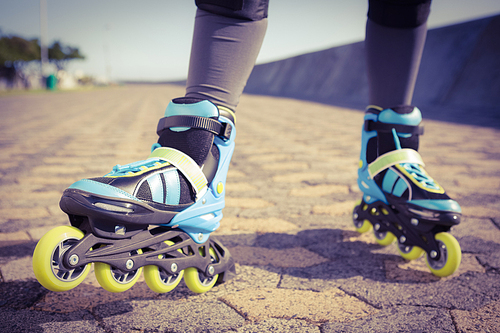유토이미지 | Close up view of woman wearing inline skates at promenade