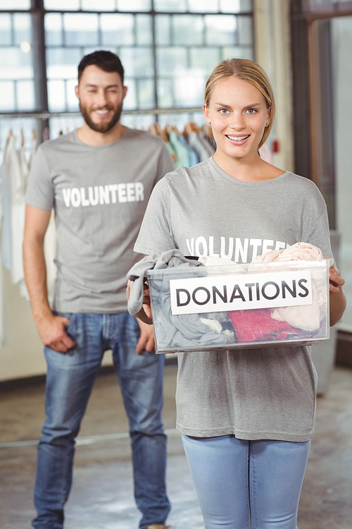 유토이미지 | Pretty volunteer holding clothes donation box