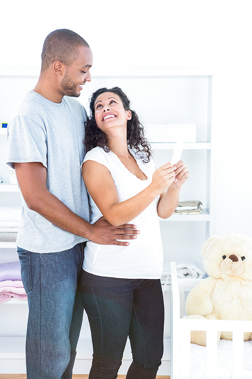 Cheerful couple enjoying standing by crib at home | 유토이미지 | 상세페이지 ...