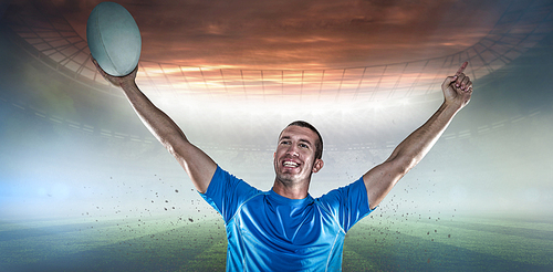 Composite image of happy rugby player in blue jersey holding ball with ...