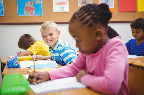 Busy students working on class work at the elementary school | 유토이미지 ...