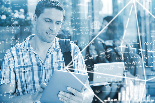 유토이미지 | Maths equation against happy student using his tablet pc on campus