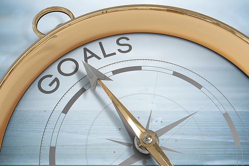 Compass pointing to goals against bleached wooden planks background ...