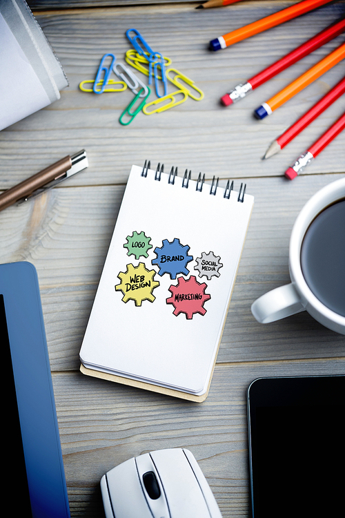 유토이미지 | business cogs and wheels against notepad on desk