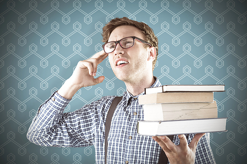 유토이미지 | Geeky student holding a pile of books against background