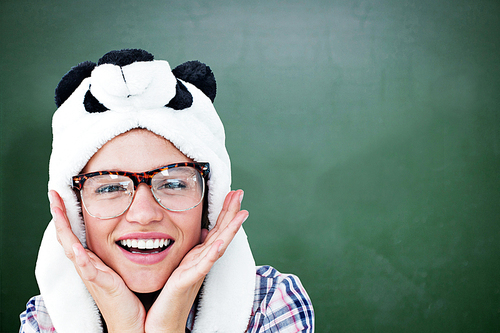 유토이미지 | Geeky hipster smiling at camera against green chalkboard