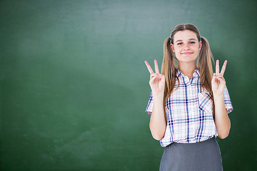 유토이미지 | Geeky hipster smiling at camera against green chalkboard