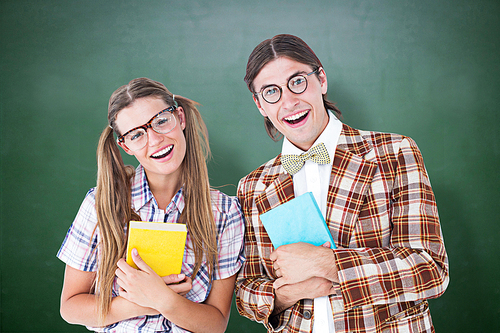 Geeky hipsters smiling at camera against green chalkboard | 유토이미지 | 상세페이지 | 베이직샵 | 사진 | 19960793