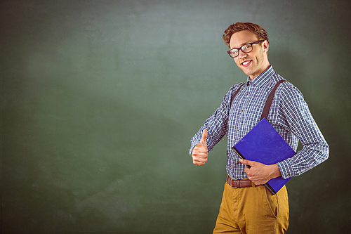 유토이미지 | Geeky student holding a notebook against green chalkboard