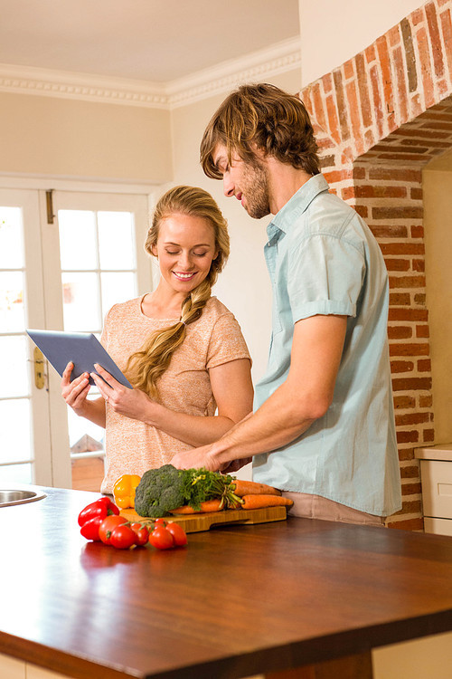Cute couple cooking and using tablet in the kitchen | 유토이미지 | 상세페이지 ...