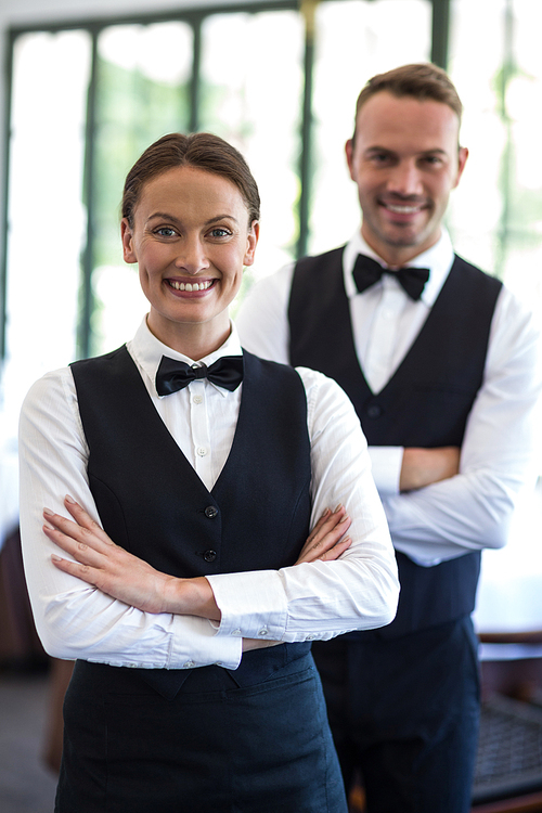 유토이미지 | Waiting staff smiling at camera in a commercial kitchen