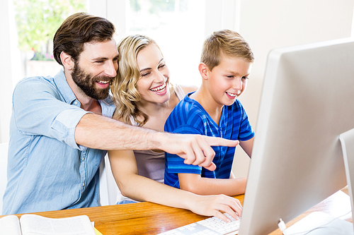 Parents and son using computer in living room at home | 유토이미지 | 상세페이지 ...