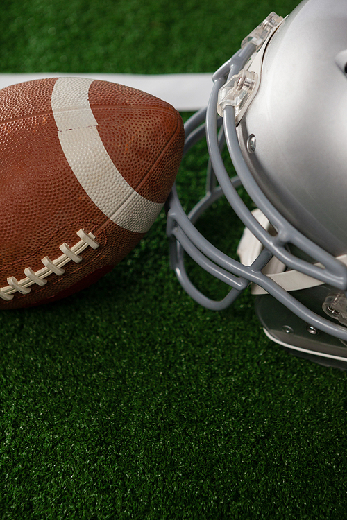 High angle view of American football by sports helmet on field | 유토이미지 ...