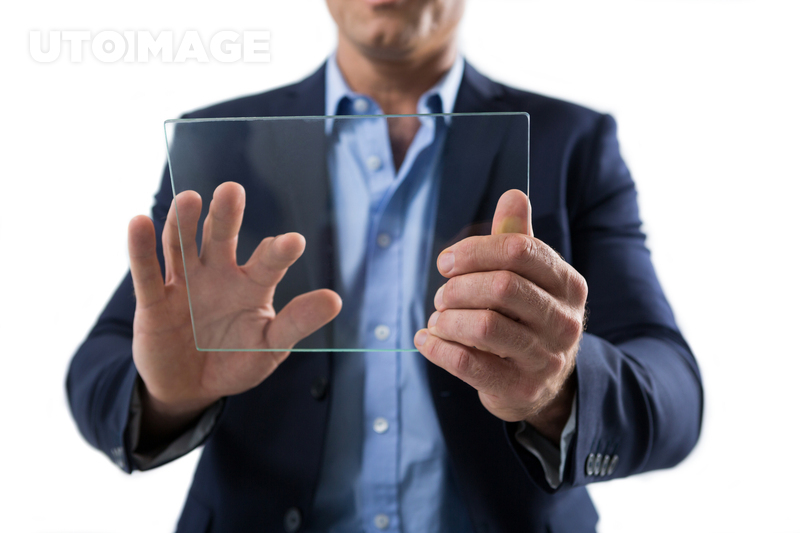 Mid section of businessman using a glass digital tablet against white ...