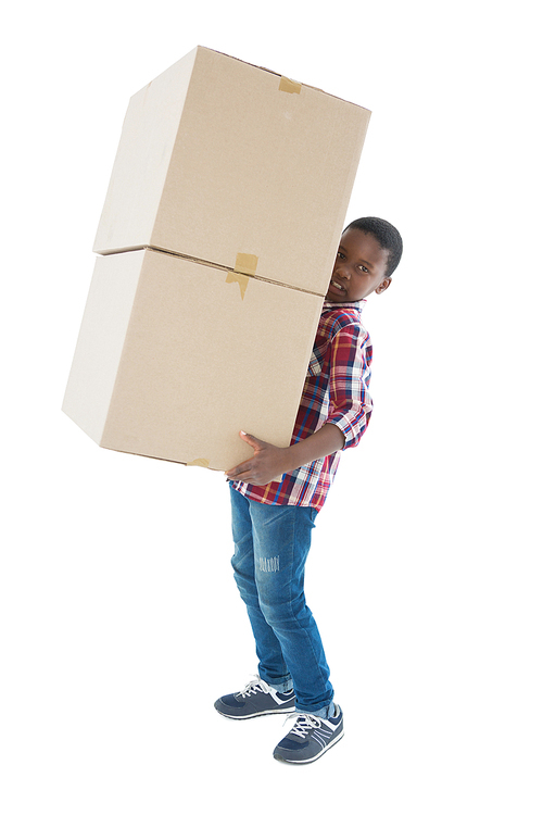 Portrait of boy carrying heavy boxes against white background | 유토이미지 ...