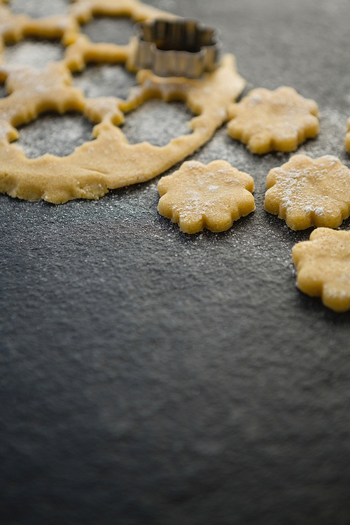 Close up of flower shape pastry cutter on dough at table | 유토이미지 | 상세 ...