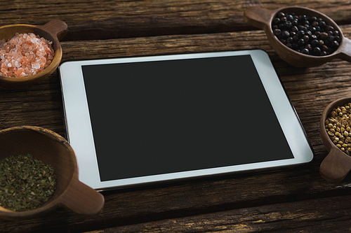 Close-up of various spices with digital tablet on wooden table | 유토이미지 ...