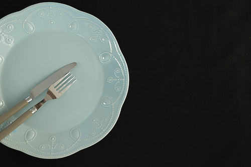 유토이미지 | Plate and cutlery set on a black theme table