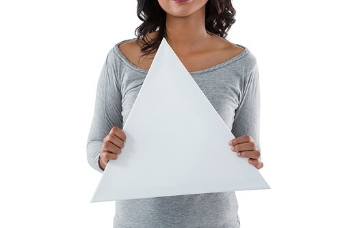 Mid section of young woman holding triangle shaped placard against ...