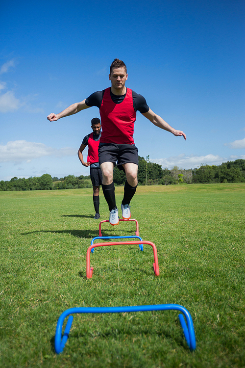 유토이미지 | Soccer players practicing on obstacle in ground
