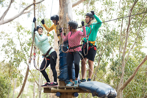 유토이미지 | Excited friends enjoying zip line adventure in park on a sunny day