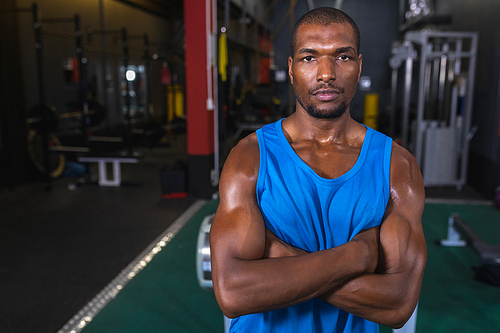 Portrait of male African-american athletic standing with arms crossed ...
