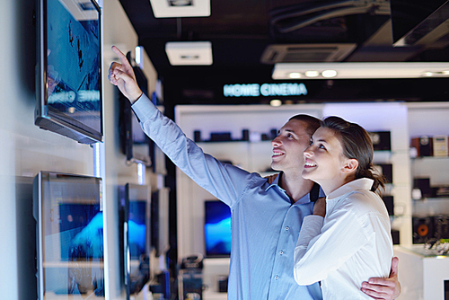 people in consumer electronics retail store looking at latest ...