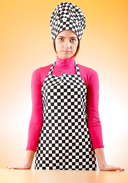 유토이미지 | Young female cook against gradient background