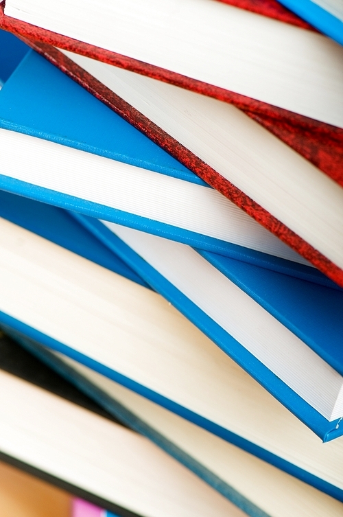 유토이미지 | Stack of text books against gradient background