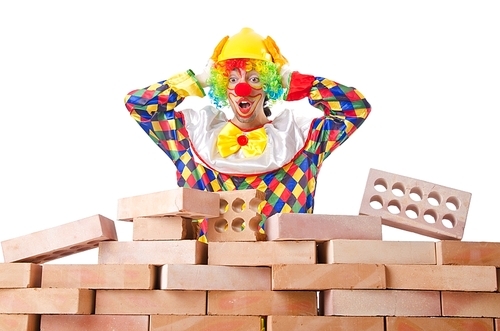 유토이미지 | Bad construction concept with clown laying bricks