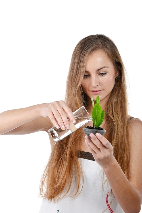 유토이미지 | Beautiful young woman pouring water from glass green sprout