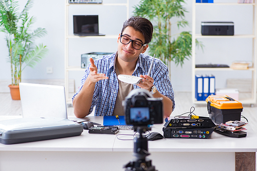 유토이미지 | Vlogger recording computer repair on camera for vlog blog