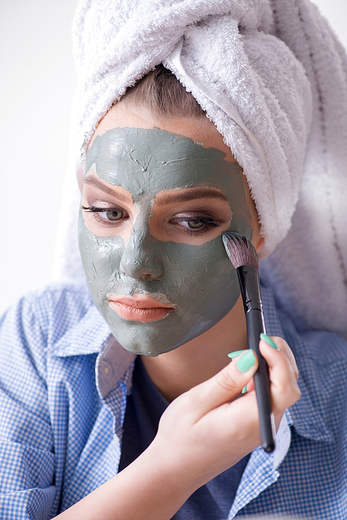 유토이미지 | Woman applying clay mask with brush at home