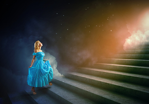 유토이미지 | Young woman in blue dress walking up the stairs
