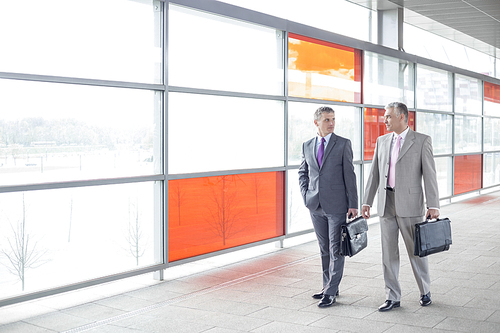 유토이미지 | Full length of businessmen with briefcase walking in railroad ...
