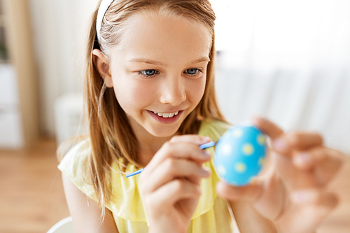 easter, holidays and people concept - happy girl coloring egg with ...