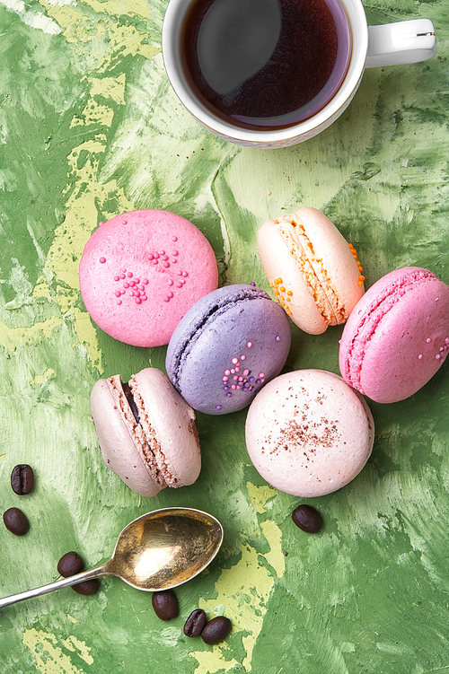 coffee and colorful French macaroons on green background | 유토이미지 | 상세 ...