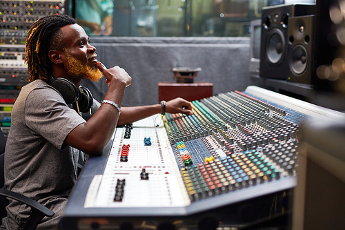 유토이미지 | Young sound operator regulating volume